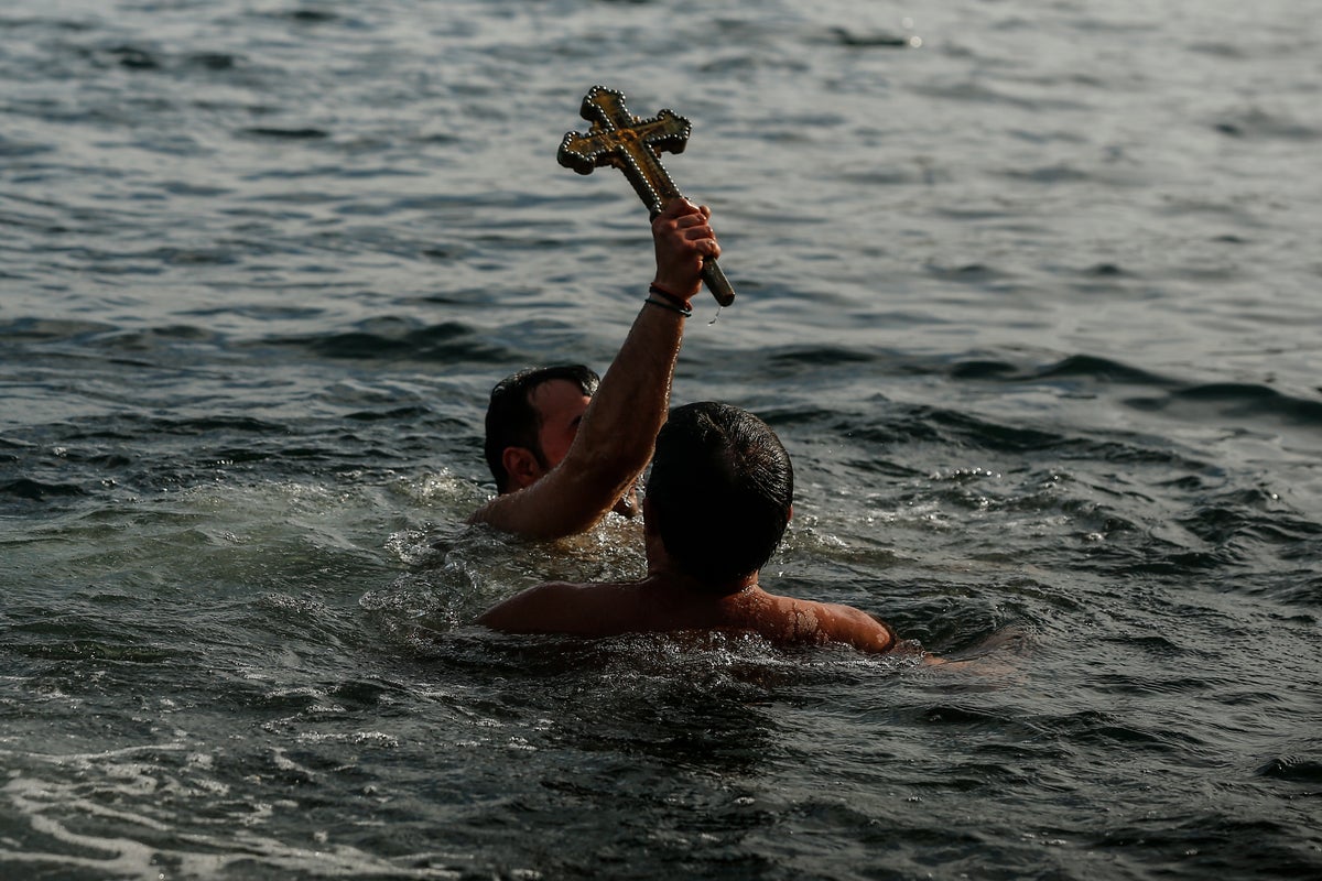 Images show Orthodox Christians defy Covid guidelines to take icy ...
