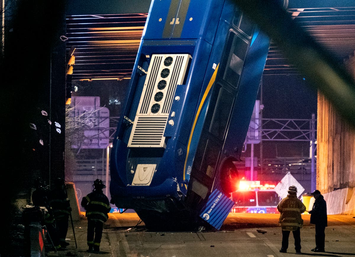 New York bus left dangling over bridge after crash | The Independent