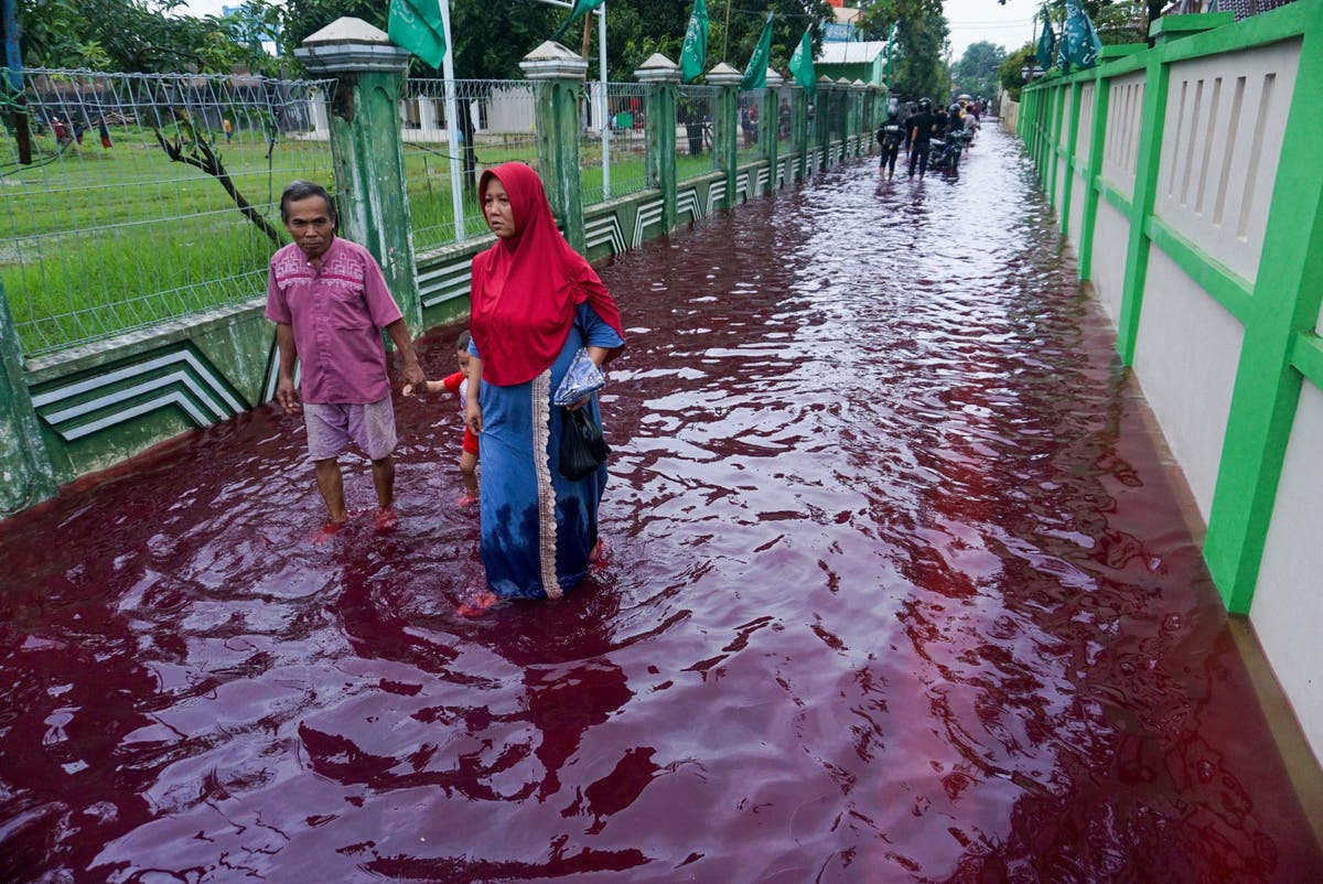 Blood-red flood swamps village in Indonesia | The Independent