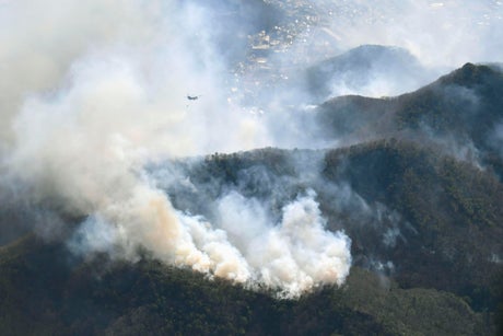 Helicopters, firefighters battle 2 forest fires in…