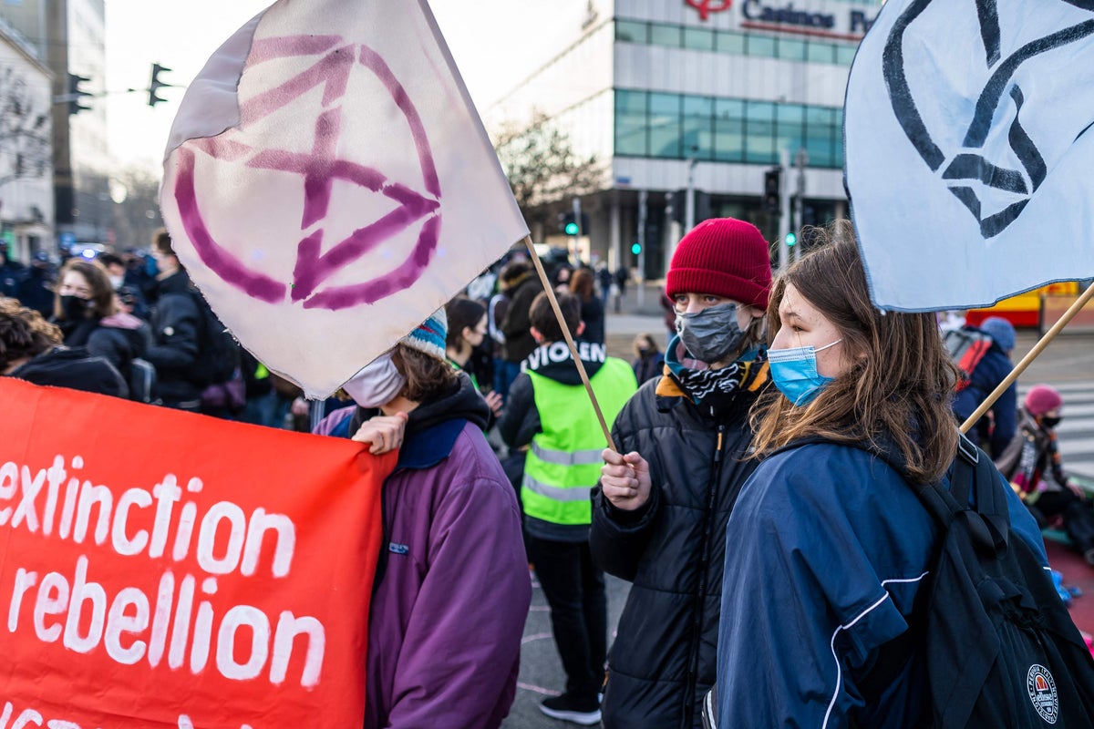 Extinction Rebellion protester arrested after climbing onto roof of ...