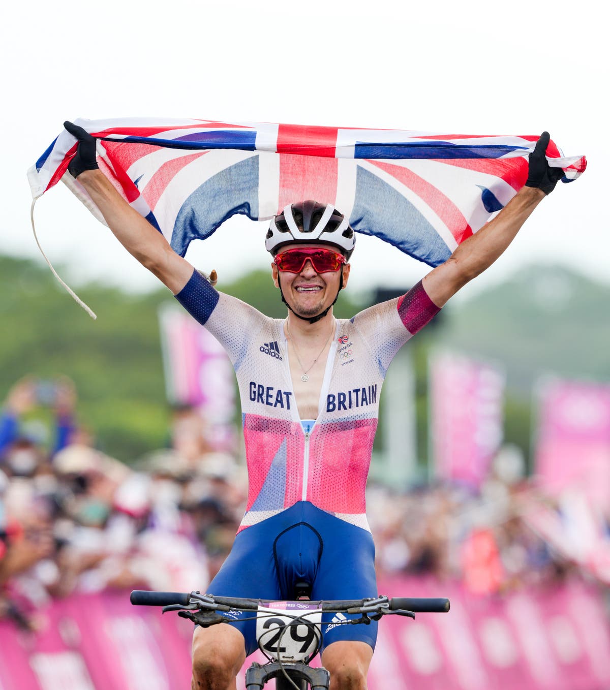 New Olympic champion Tom Pidcock remains on his bike as he prepares for ...