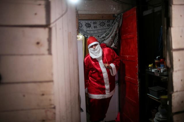 Santa Claus hands out gifts in Rio’s City of God slum | The Independent