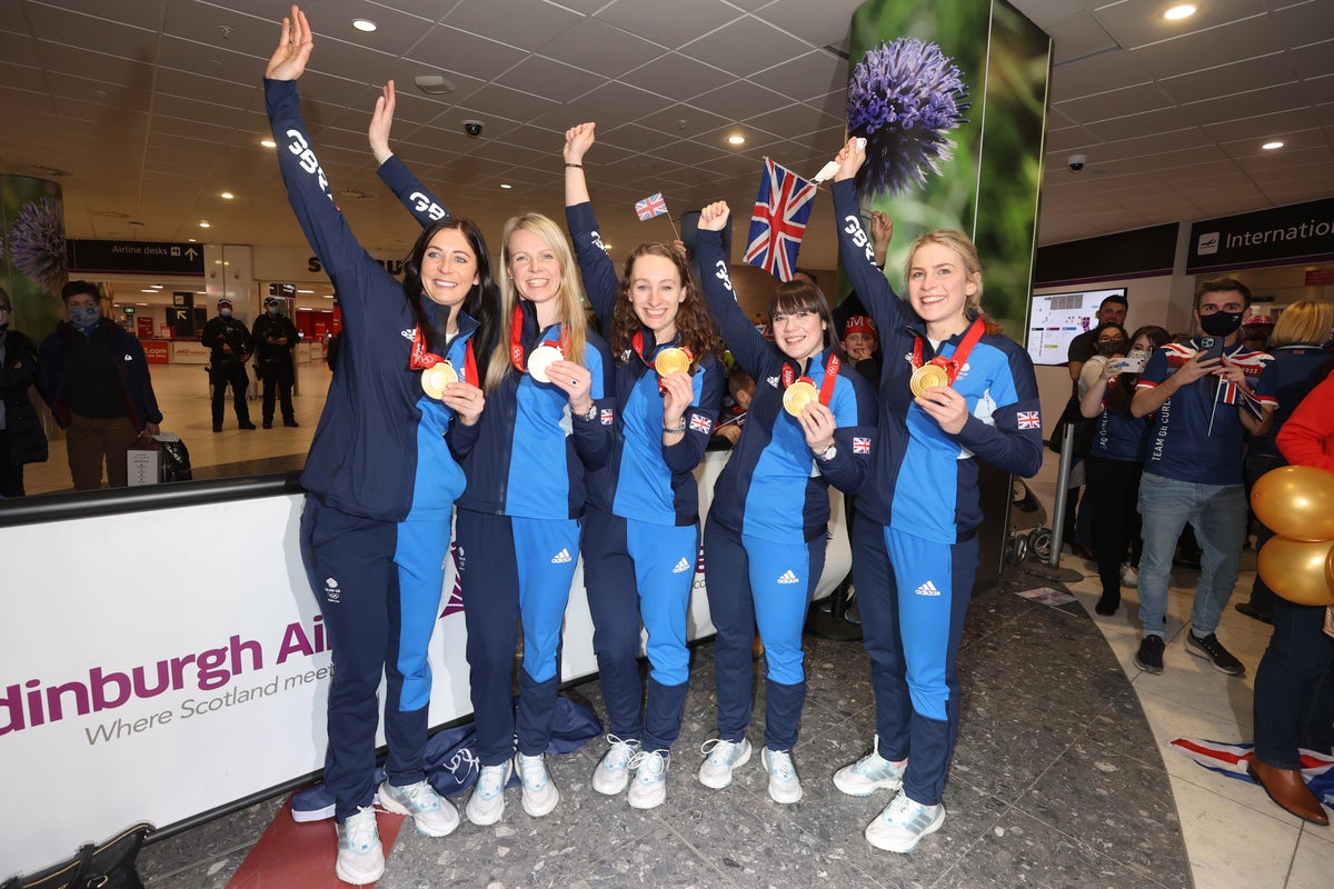 Triumphant Olympic curling teams land in Edinburgh | The Independent