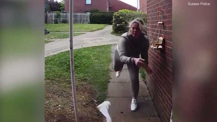 Woman throws petrol bomb at house with children inside in CCTV footage ...