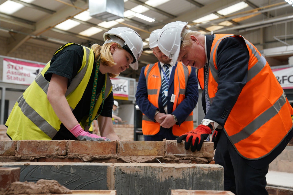Johnson tries hand at bricklaying on visit intended to help cement his ...
