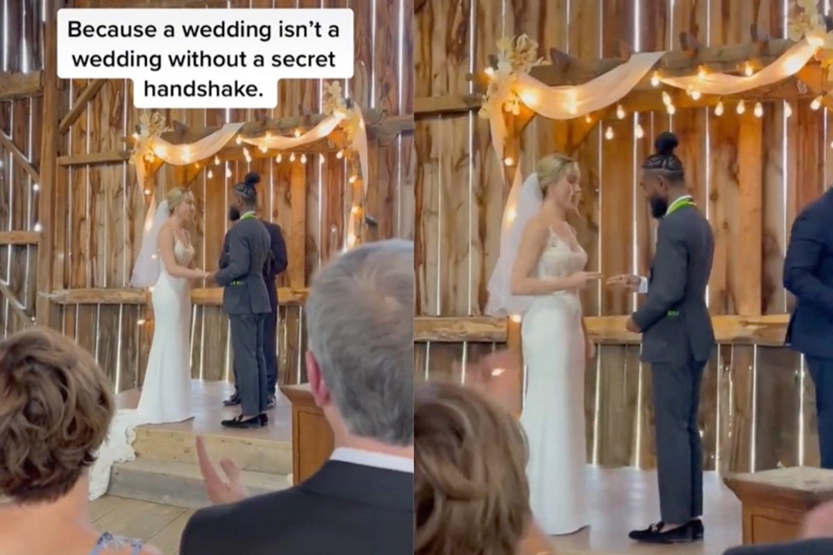 Bride and groom surprise wedding guests with secret handshake at the ...