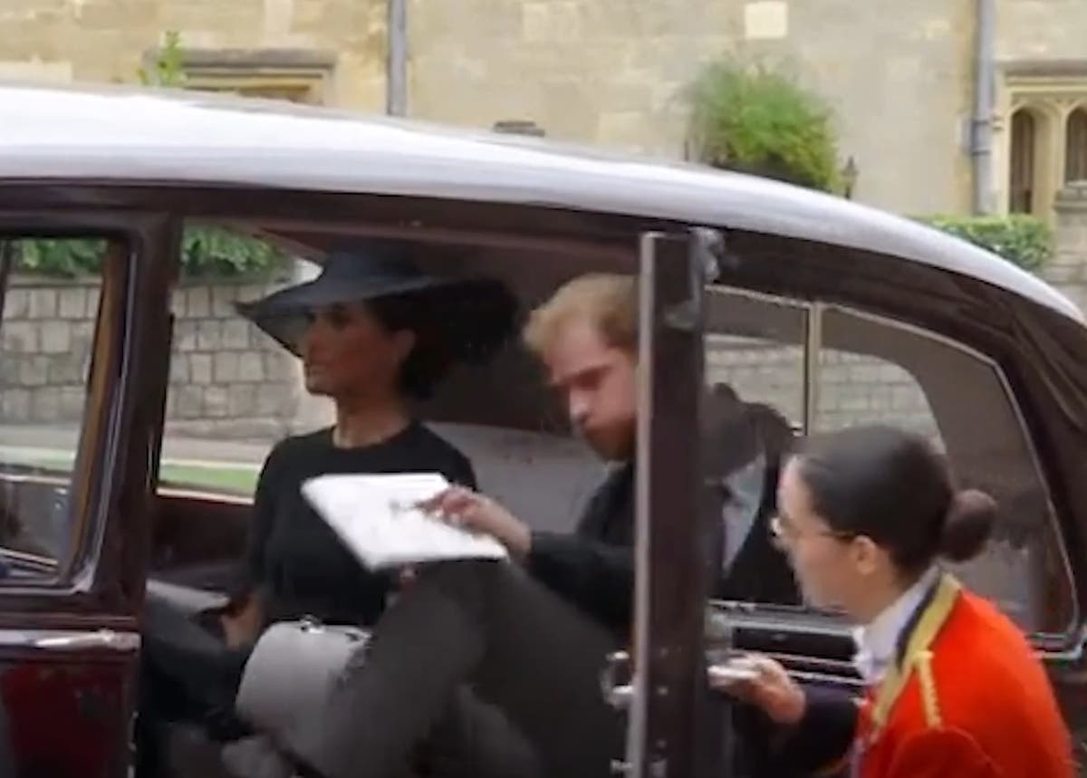 Emotional Prince Harry puffs out his cheeks as he gets into car with ...