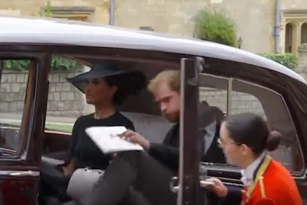 Emotional Prince Harry puffs out his cheeks as he gets into car with ...