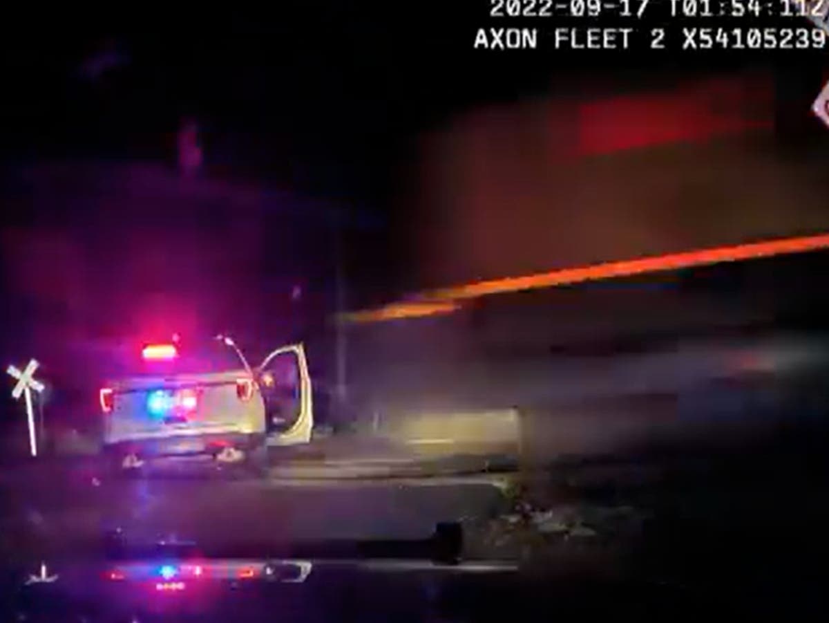 Harrowing moment train hits a parked Colorado police car with suspect inside | The Independent