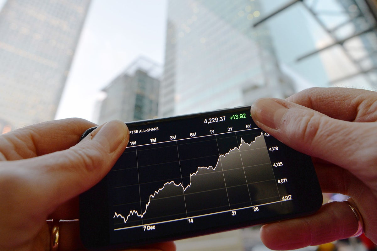 FTSE 100 holds onto gains as Liz Truss loses grip on power | The ...