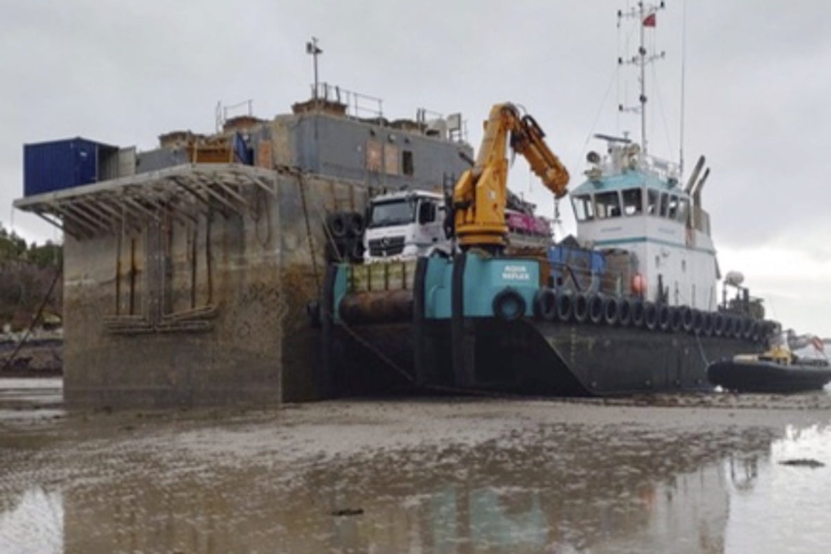 ‘Toxic’ barge that sank more than a year ago is still beached in a ...