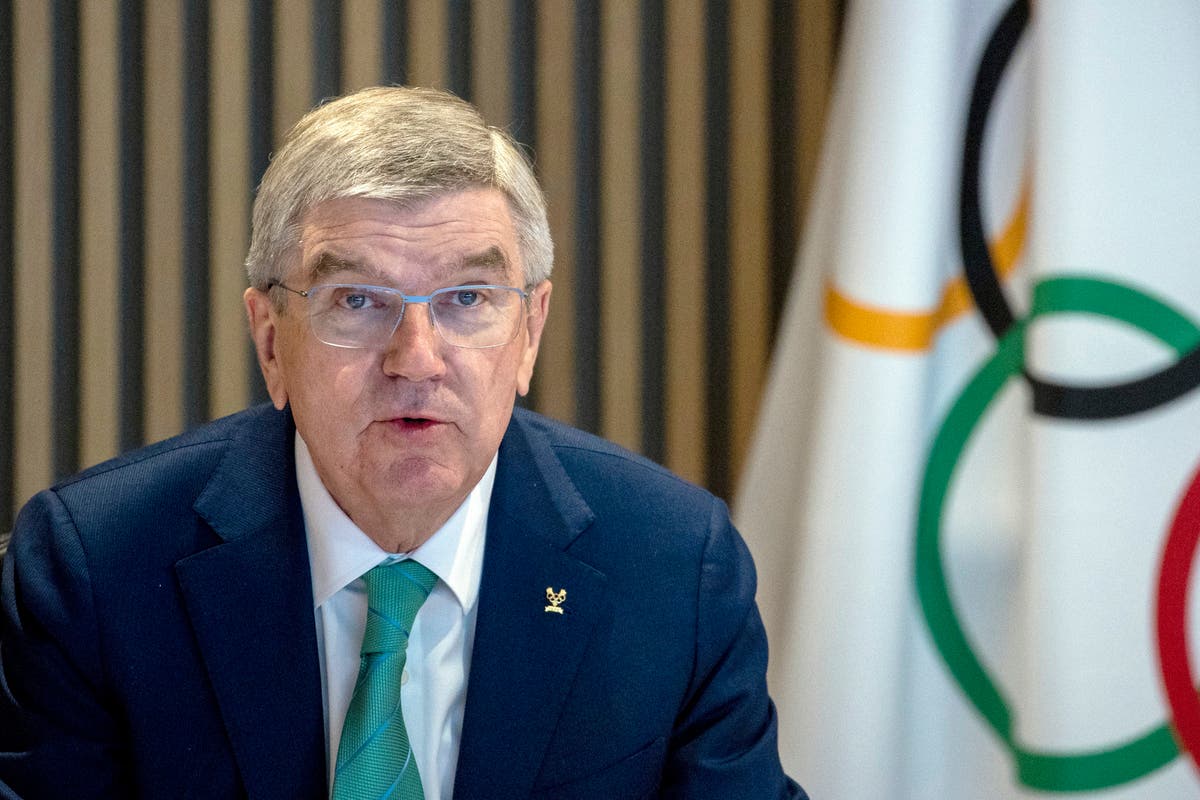 IOC's Bach defends Russia stance amid pro-Ukraine protest | The Independent