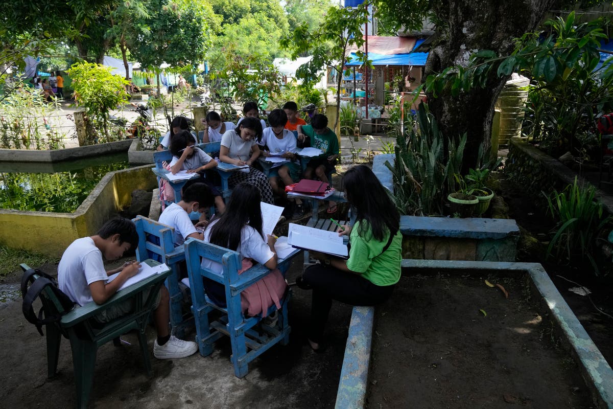 Students meet under trees as schools shelter villagers displaced by ...