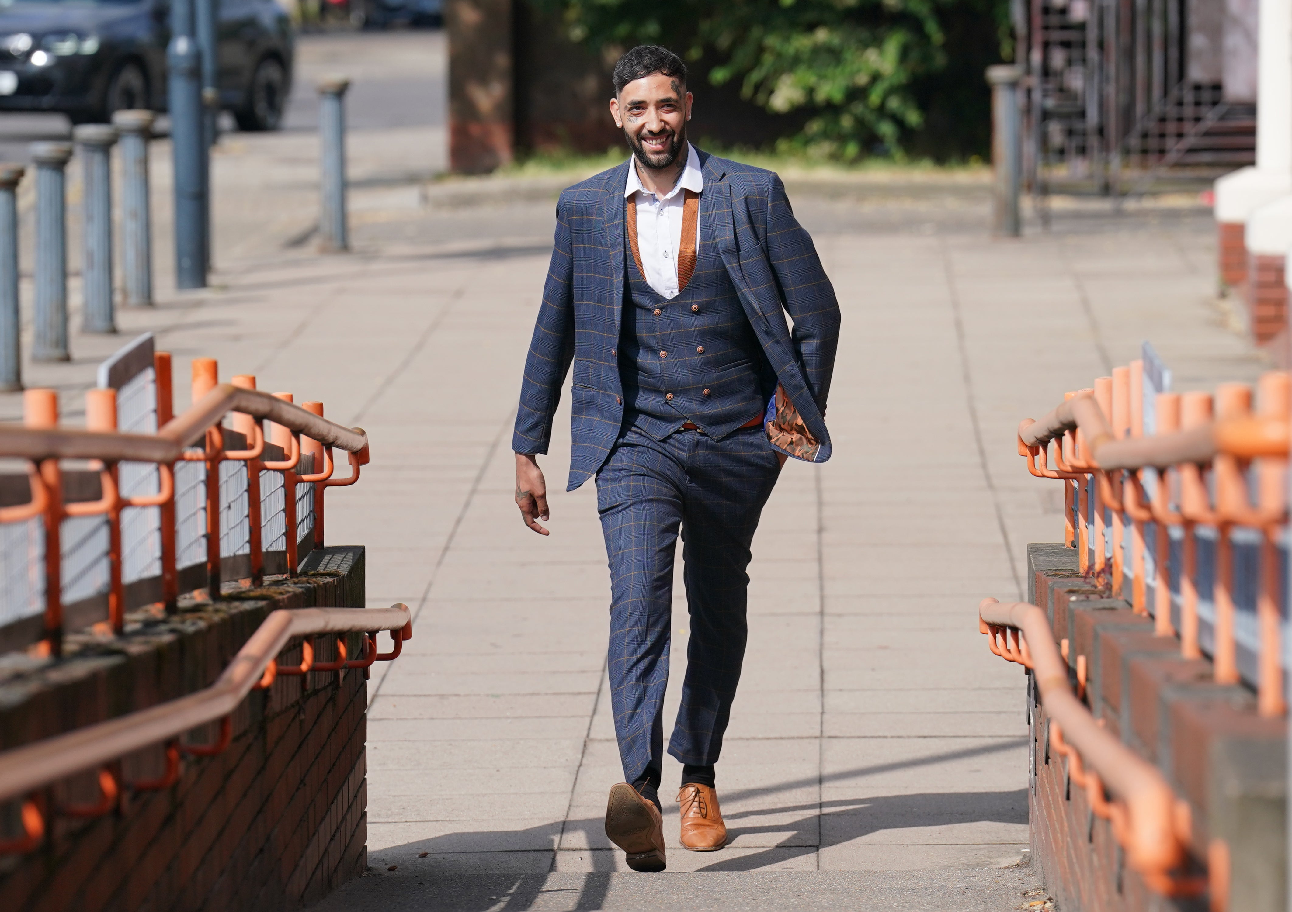 Man chuckles in court after receiving football ban for…