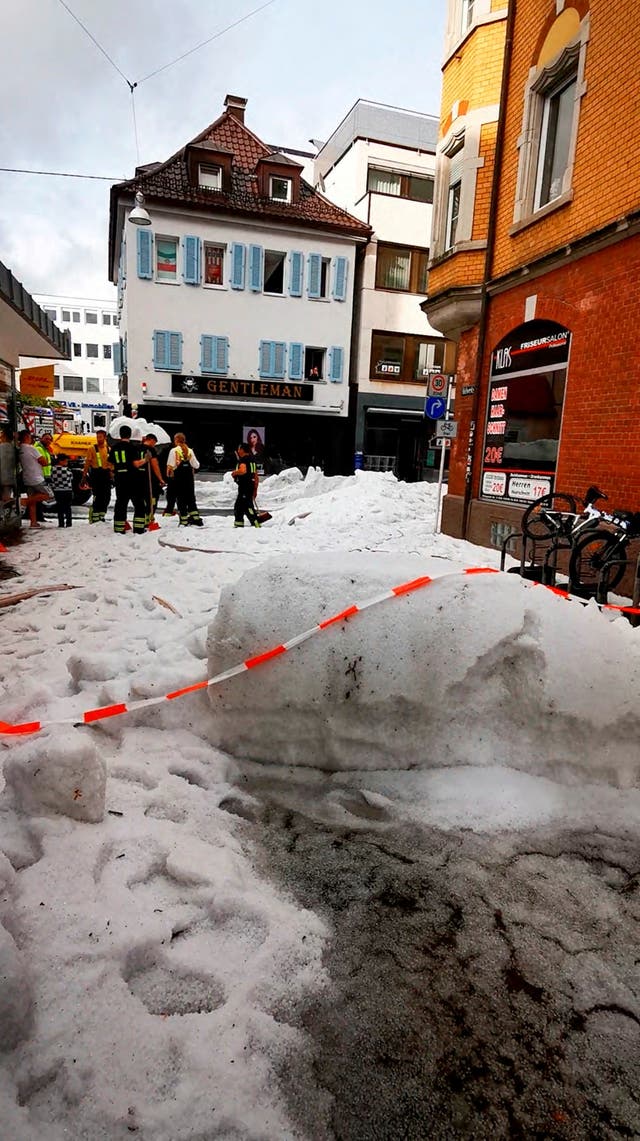 Snowploughs clear German town’s streets after freak hail storm | The ...
