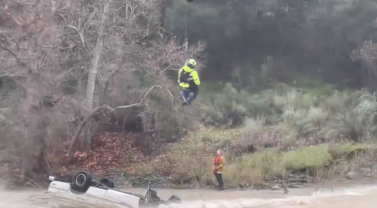 Woman rescued from top of submerged car after 15 hours | The Independent