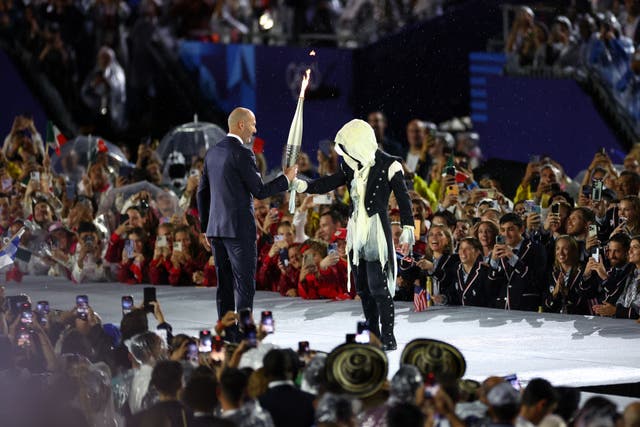 Who were the masked torchbearer and horse rider at the Olympics opening ...