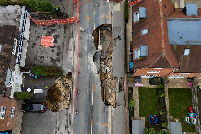 Second sinkhole opens in Surrey village as residents left unable to ...