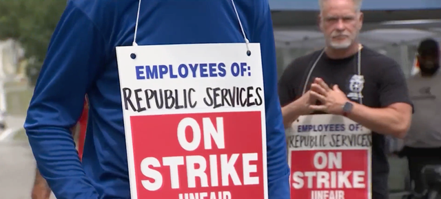 Sanitation workers remain on strike with mounds of trash piling up in ...