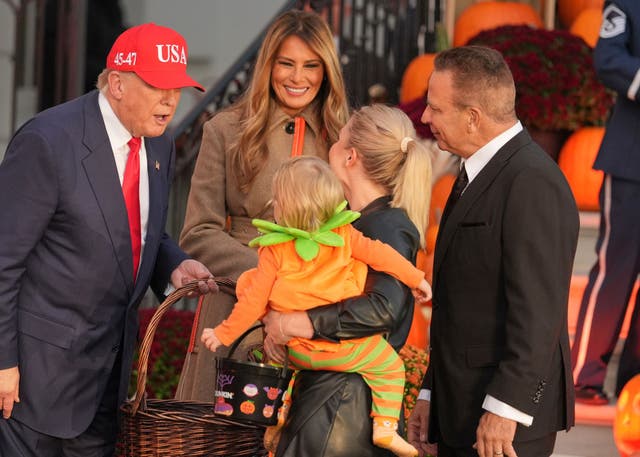 Trump puts candy on kid’s costumed head at White House Halloween event ...