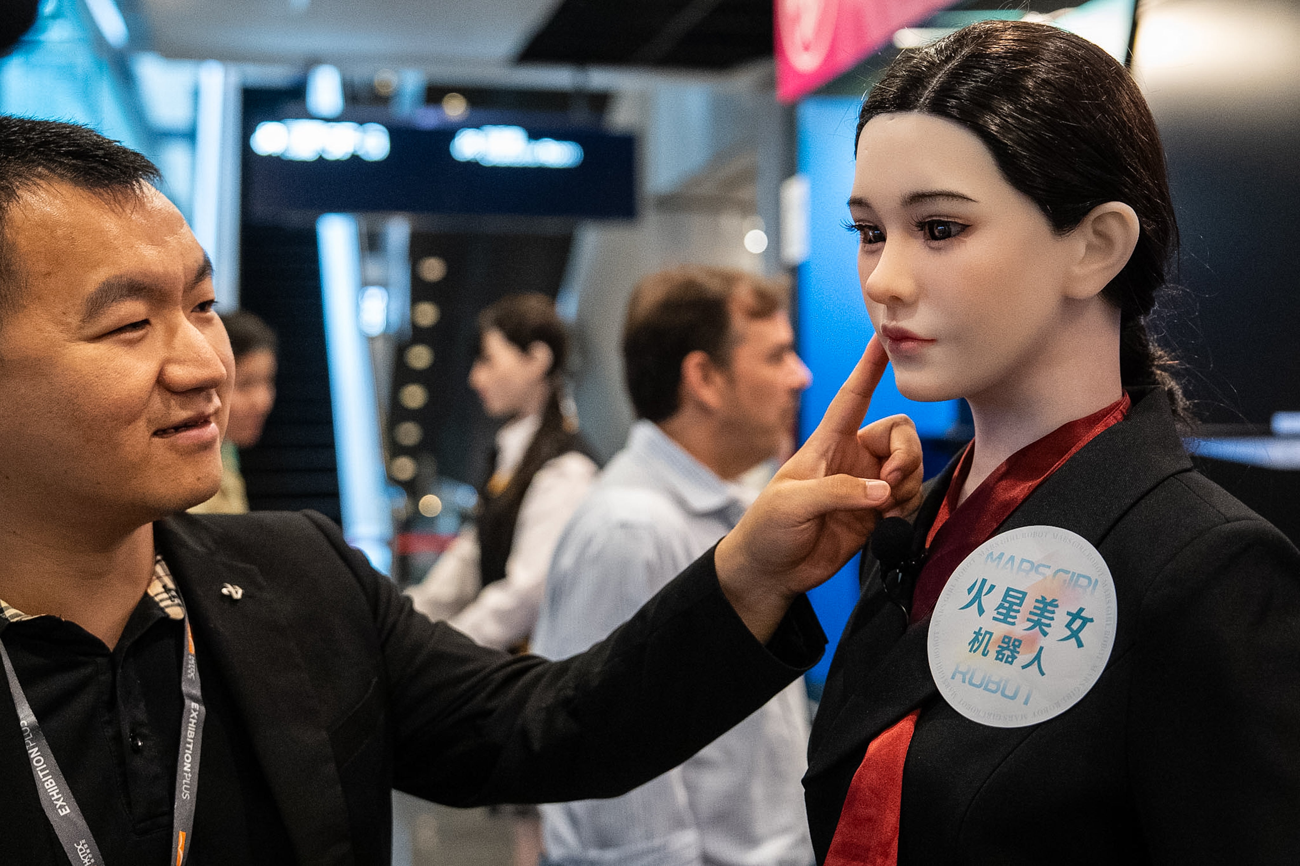 Humanoid robots show off boxing and customer service skills as they ...