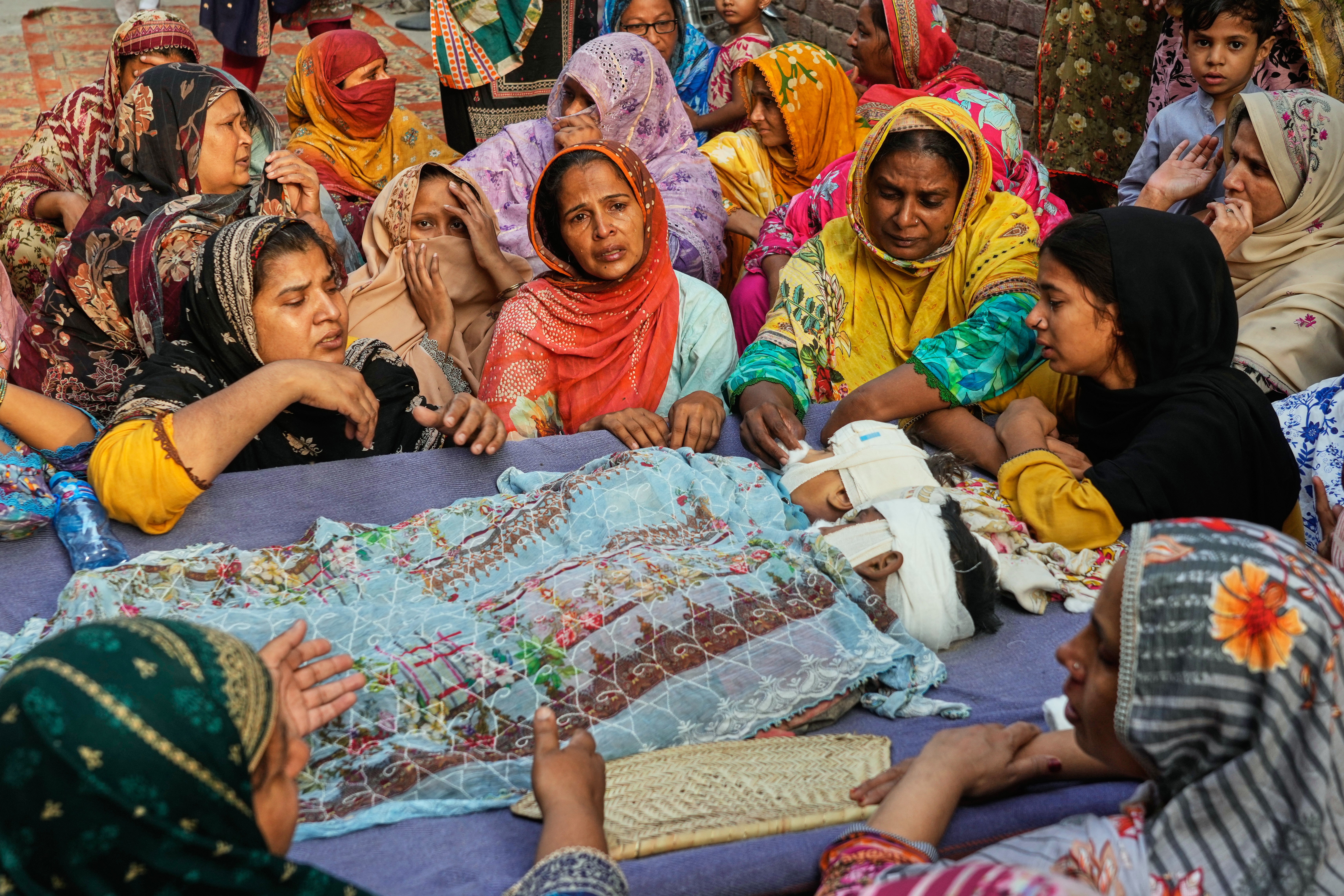Mourners attend funerals for 14 Pakistani children killed in tutoring ...
