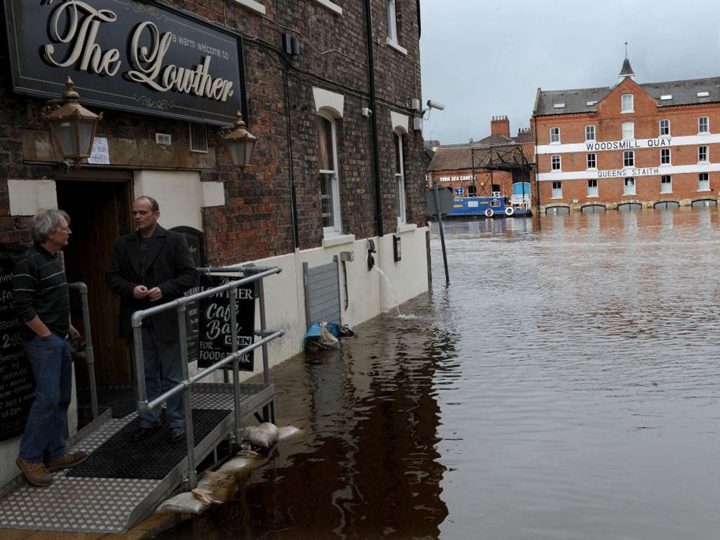 Flood warnings as Britain is battered by high winds and heavy rain ...