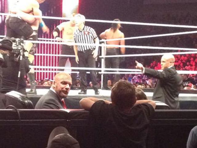 WWE heel Triple H breaks character during Raw to console a young boy ...