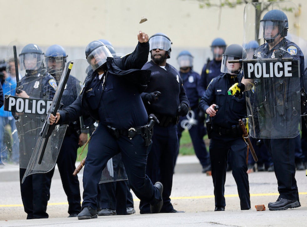 Baltimore police officer throws rock at protesters during riots | The ...