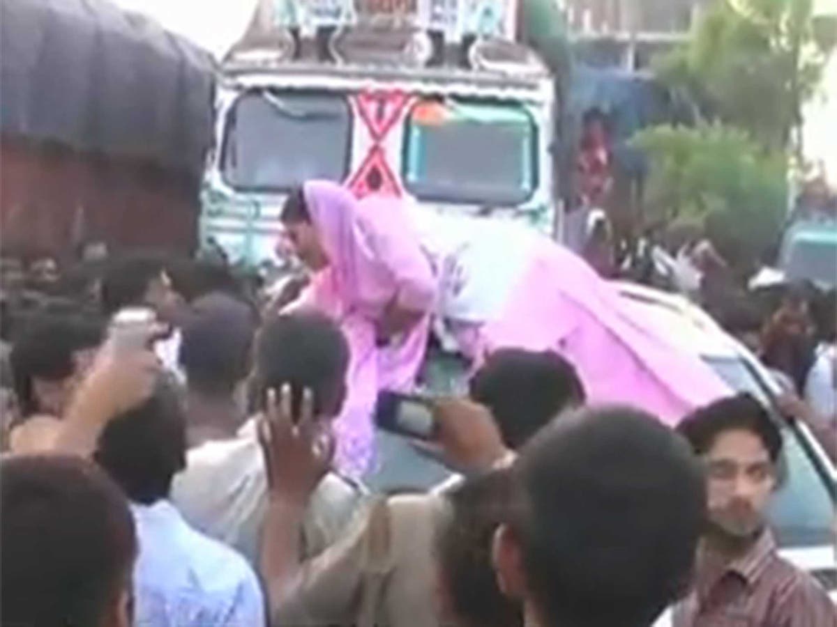Indian woman protests on top of politician's car after his guard ...