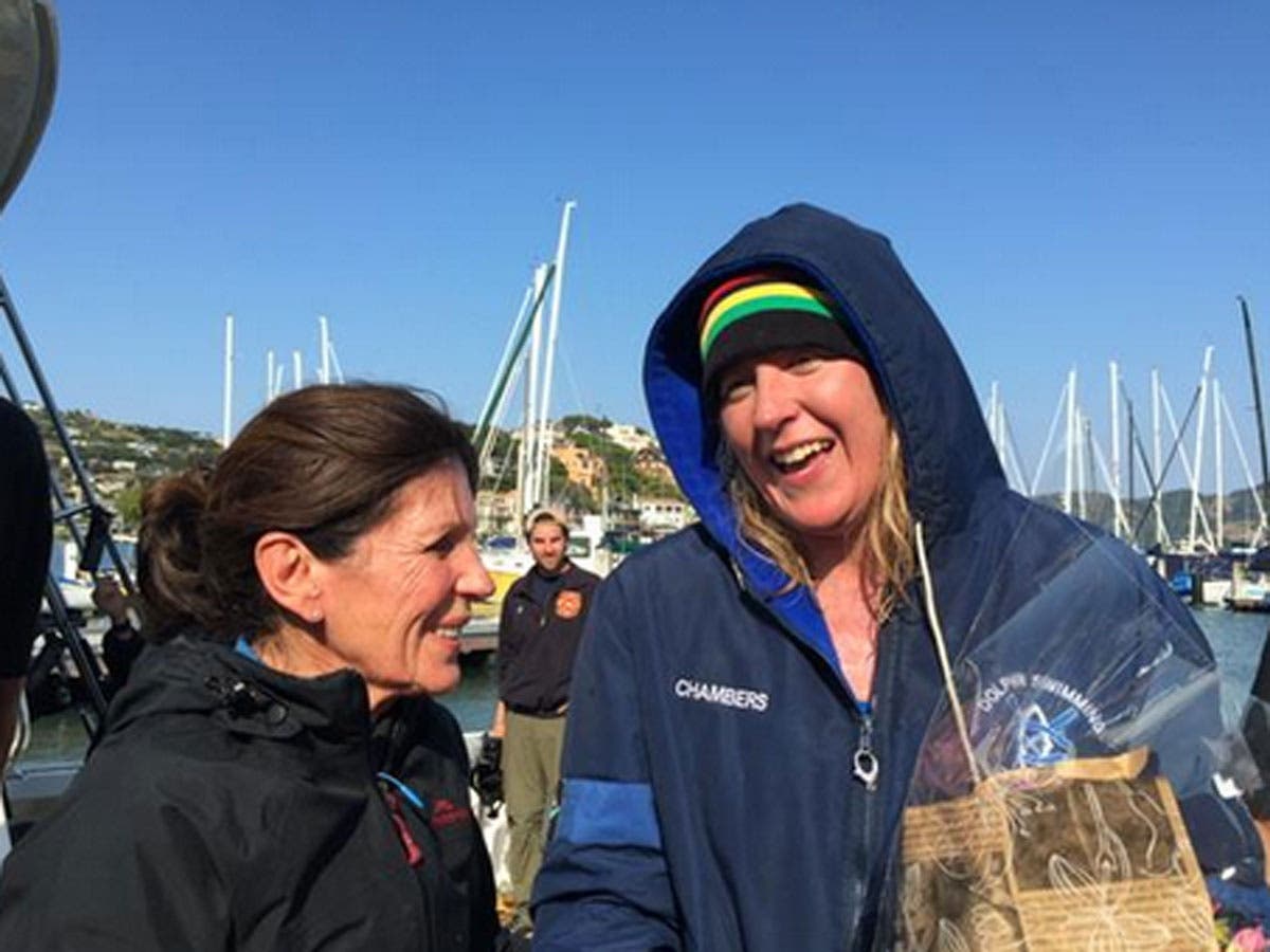 Woman who nearly lost her leg completes record swim through shark ...