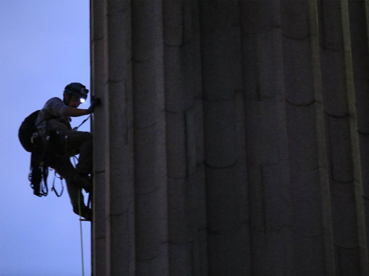 Greenpeace activists scale Nelson's Column and deface statues across ...