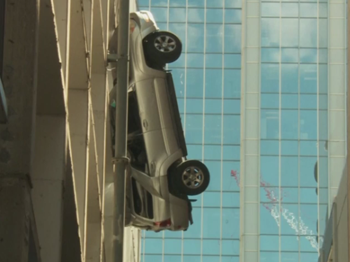 Car dangles above walkway after veering off ninth floor of car park ...