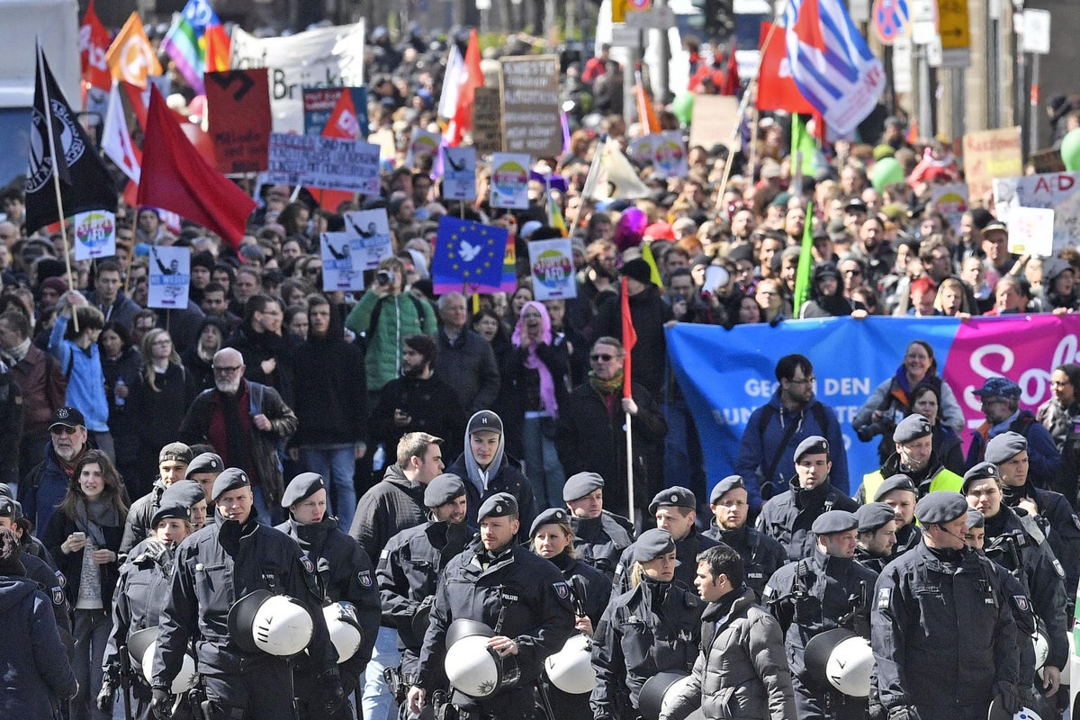 Police injured and car set alight in protests against nationalist AfD ...