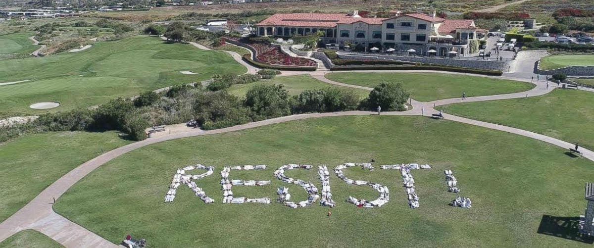 Hundreds of protesters descend on Trump golf course to spell out word ...