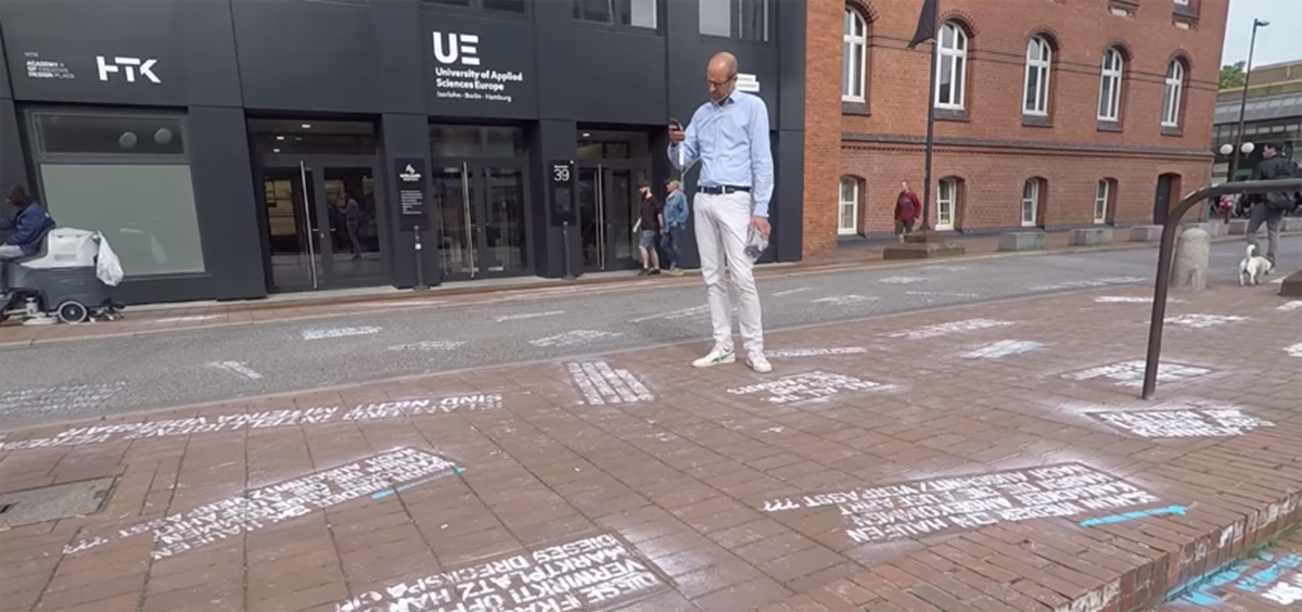 Artist stencils hate speech tweets outside Twitter HQ to highlight ...