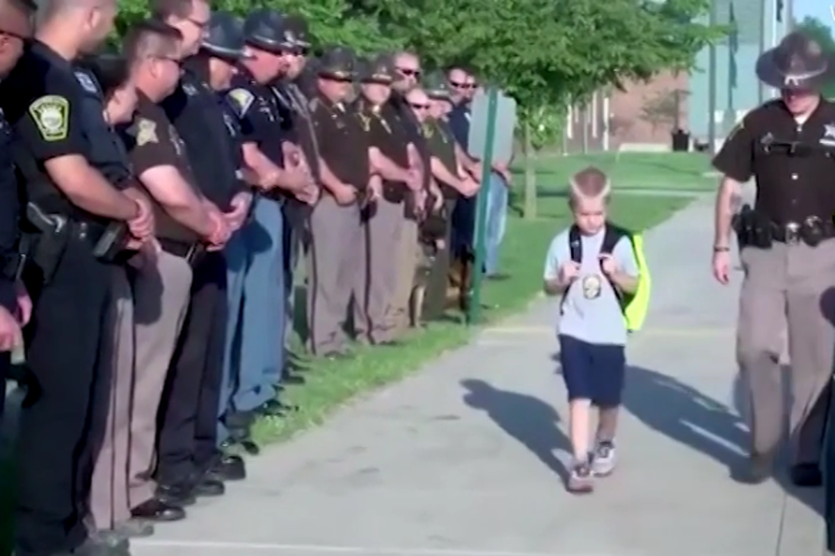 70 police officers escort five-year-old boy back to school after father ...
