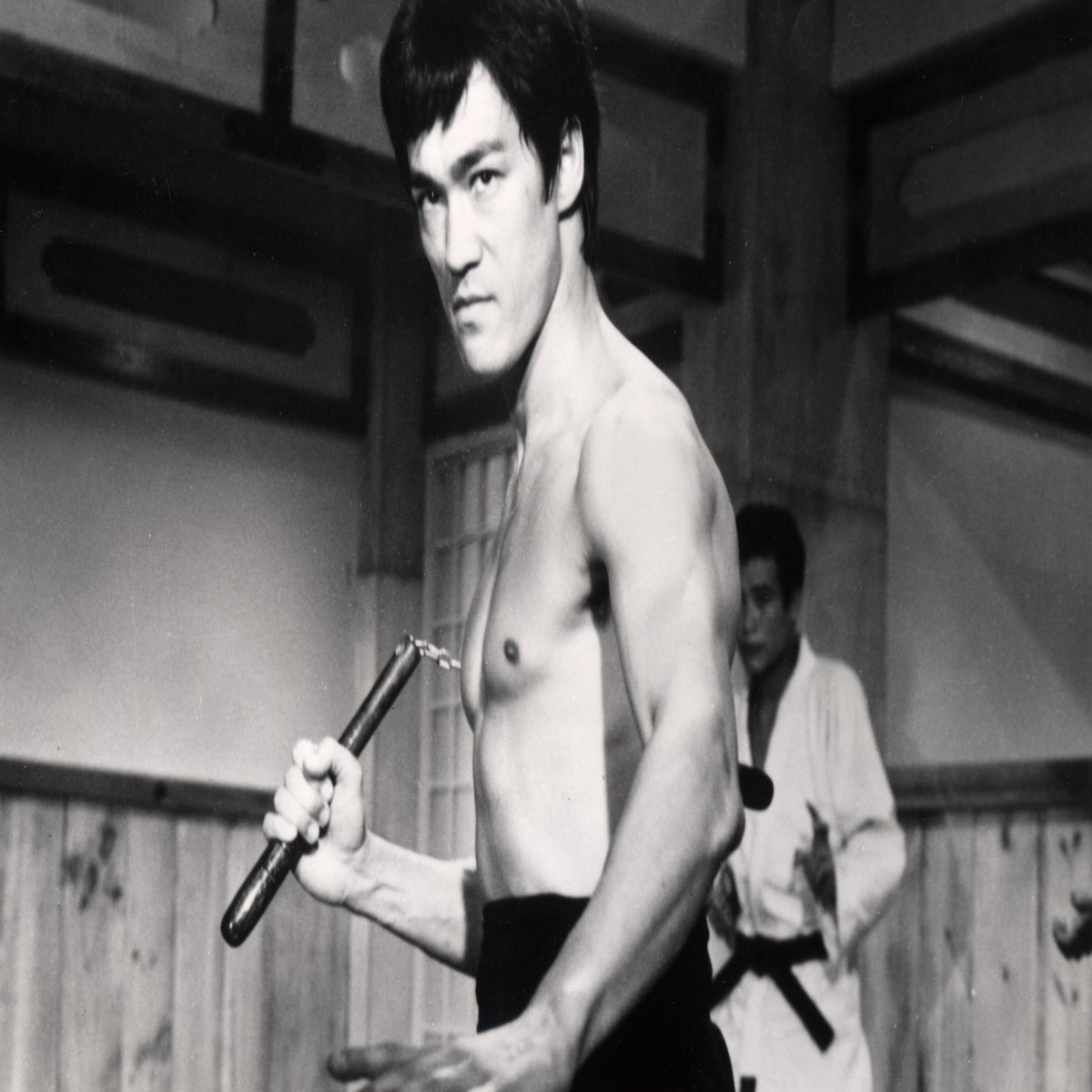 Bruce Lee Holding Nunchucks