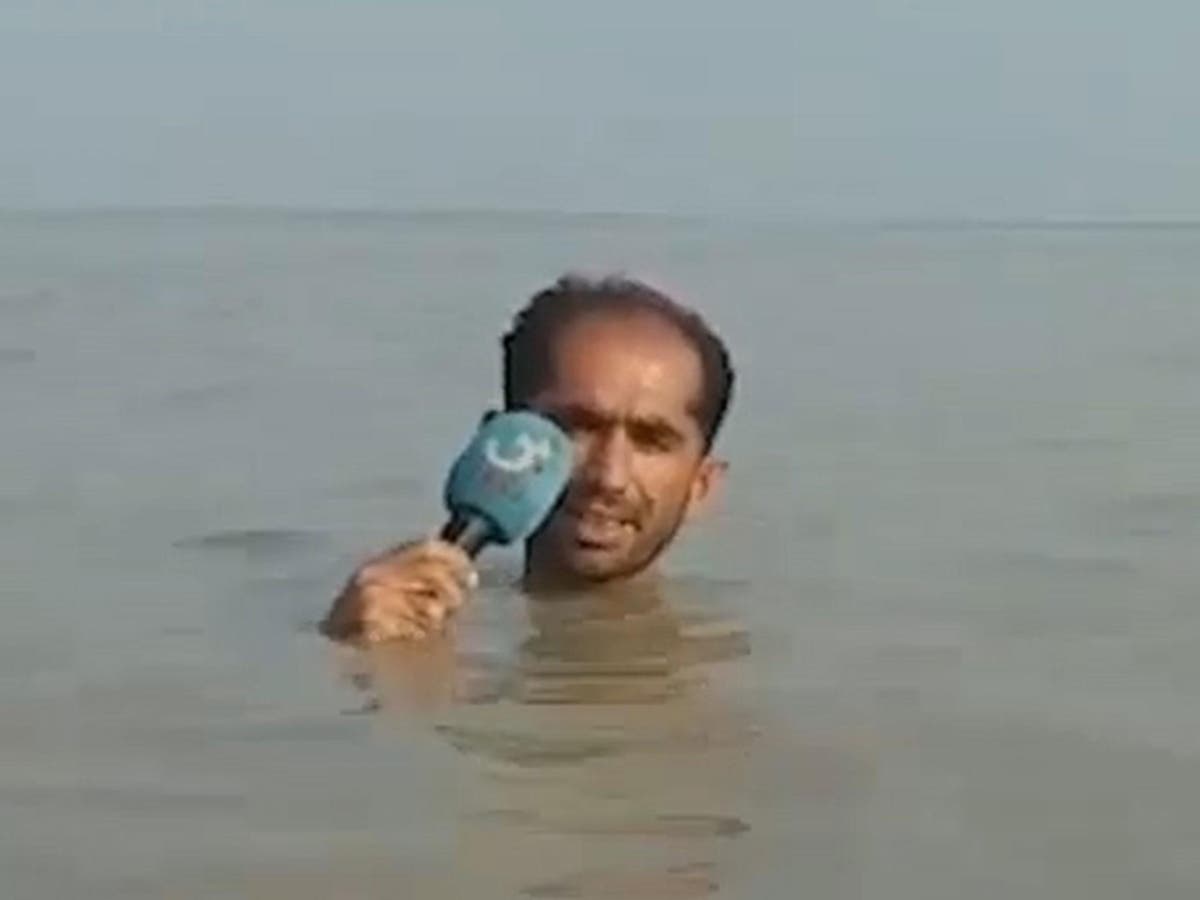 Journalist reports in neck-deep water during extreme flooding in ...