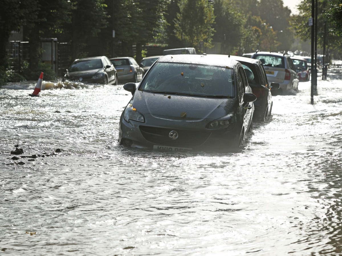 Firefighters evacuate residents from flooded London street after burst ...