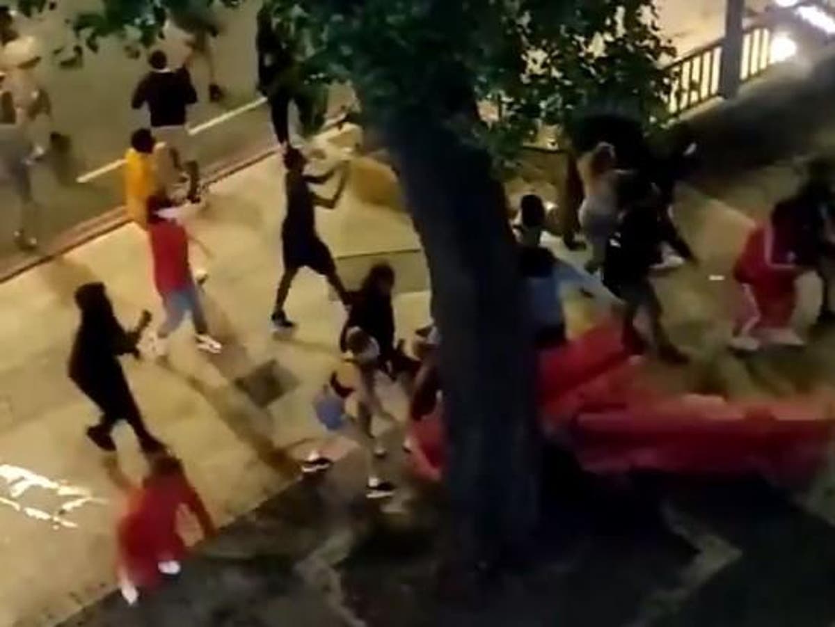 Violence flares as revellers clash with riot police trying to break up ...