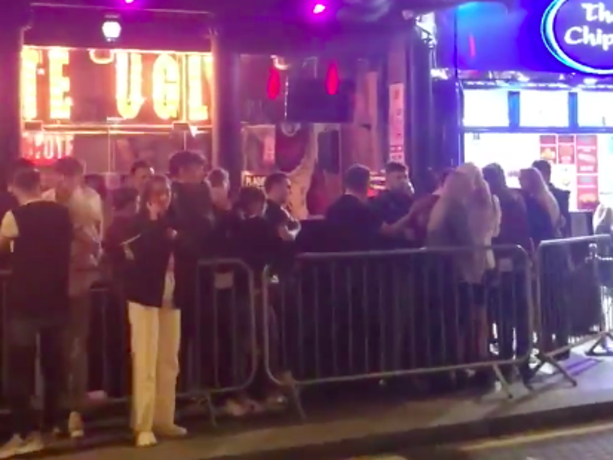 Long queues pictured outside pub despite social distancing restrictions ...